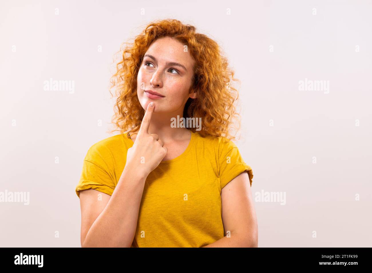 Beautiful ginger woman thinking and looking away Stock Photo - Alamy