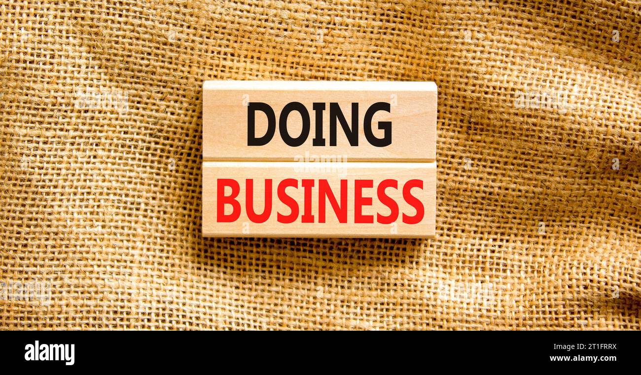 Doing business symbol. Concept words Doing business on beautiful wooden ...