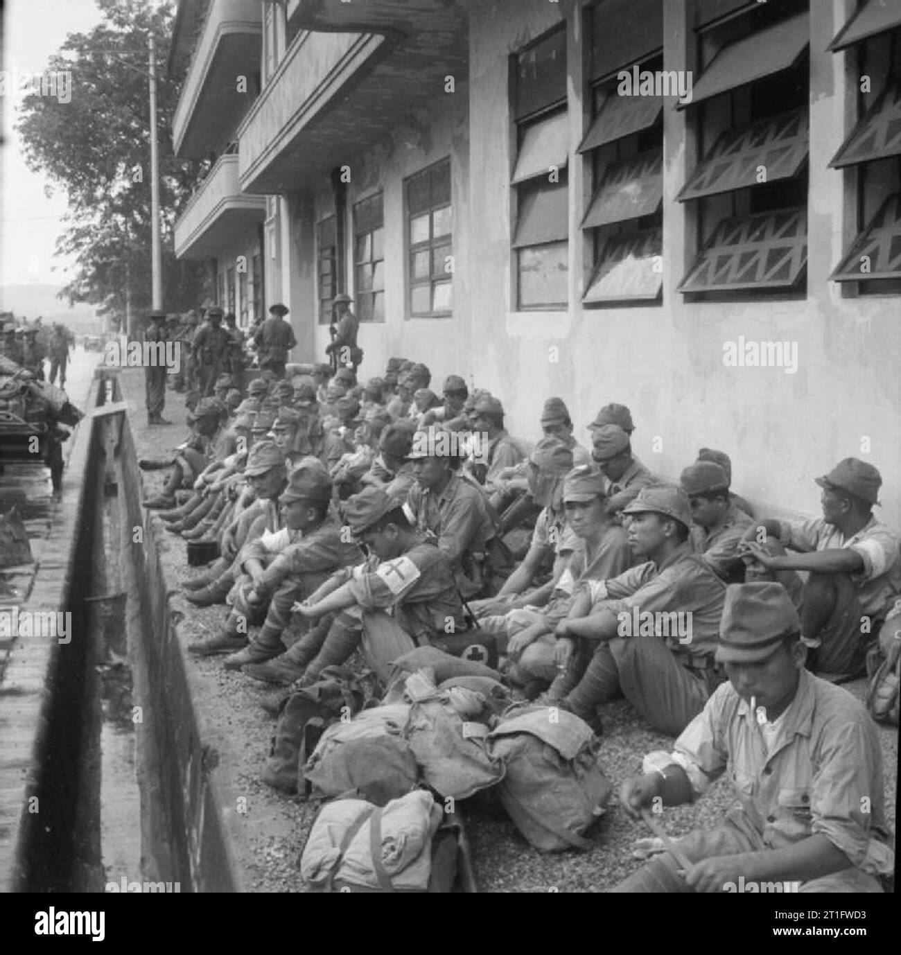 British Reoccupation of Singapore, 1945 Japanese soldiers sit by the ...