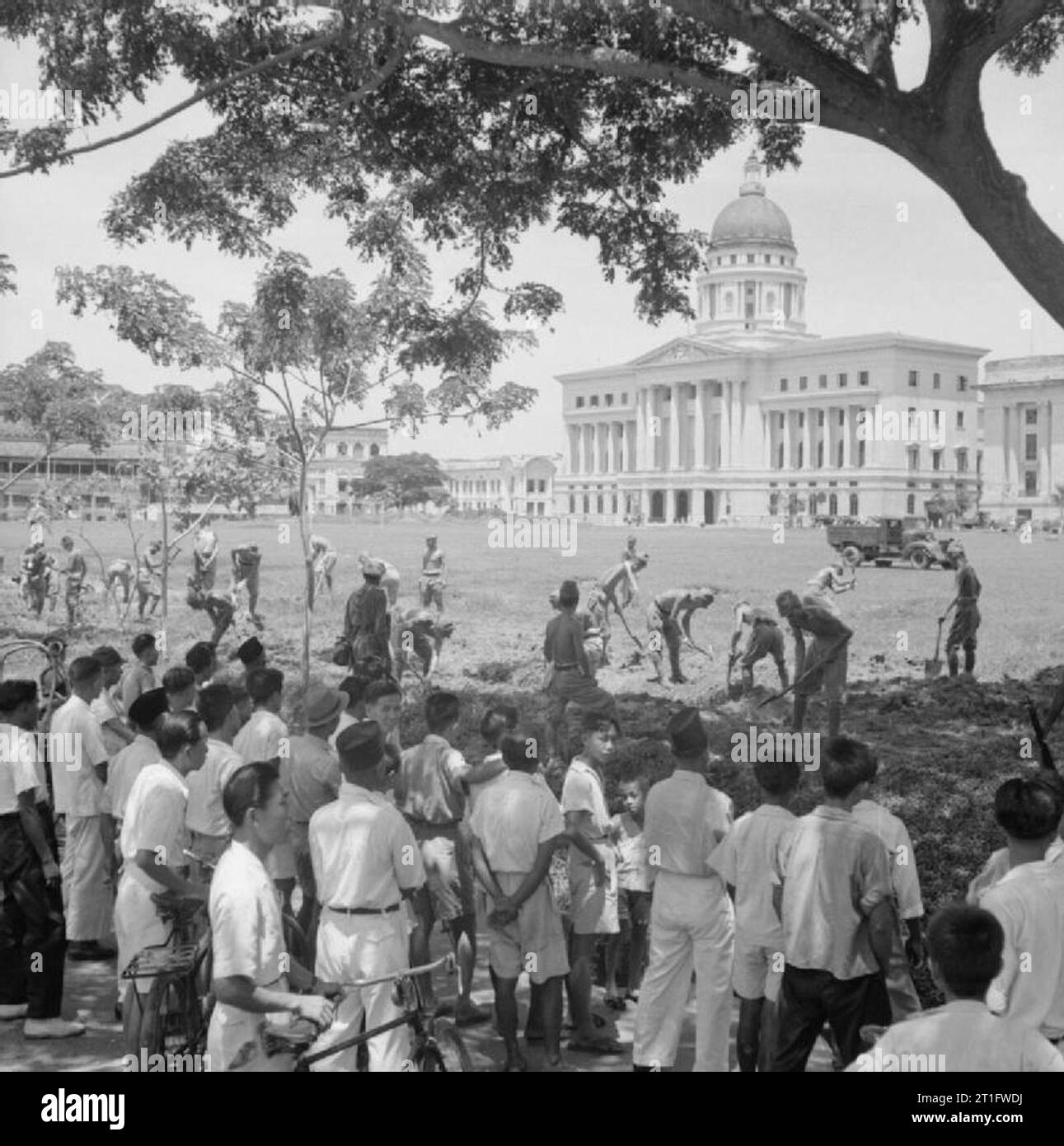 Japanese Prisoners of War at work in Singapore Local civilians watch ...
