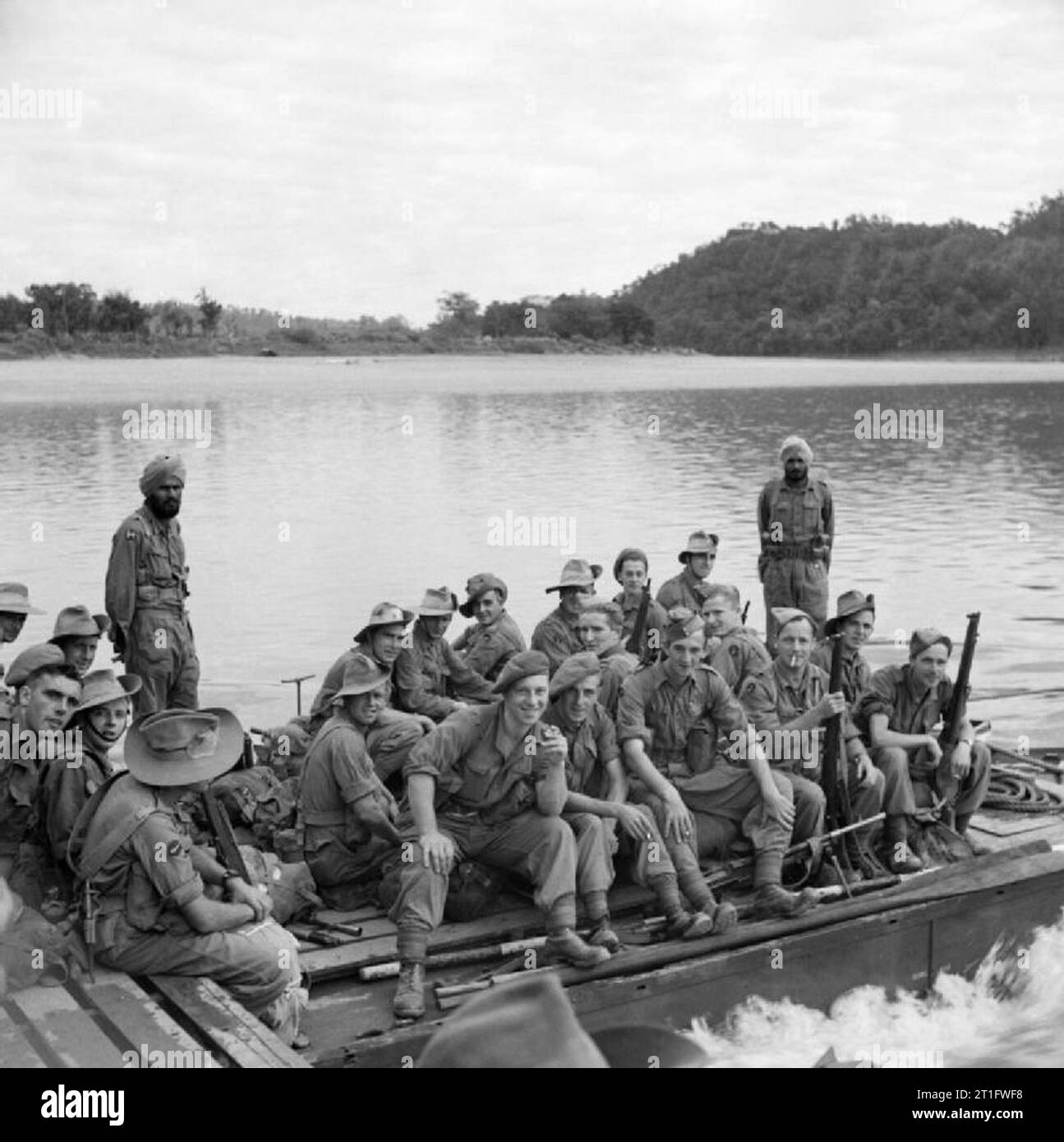 Men of the Border Regiment on a ferry ready to cross the Chindwin River ...