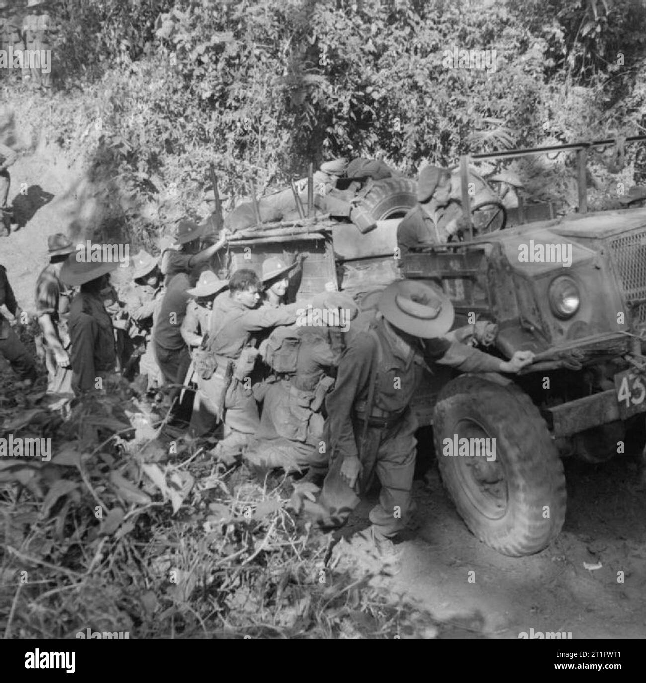 The British Army in Burma 1945 Men of the 36th Infantry Division push a ...
