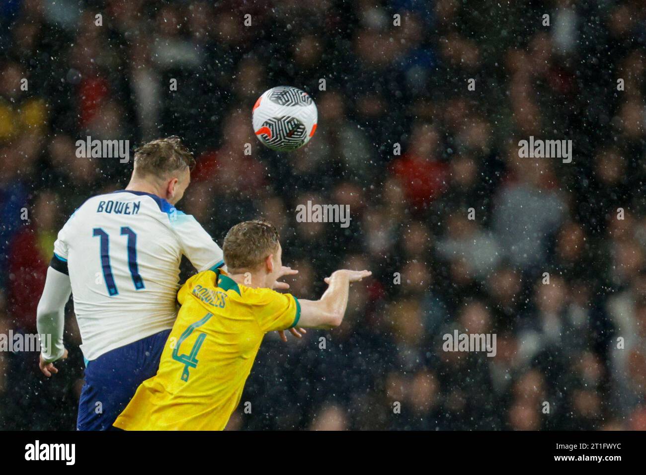 England's Jarrod Bowen, left, duels for the ball with Australia's Kye ...