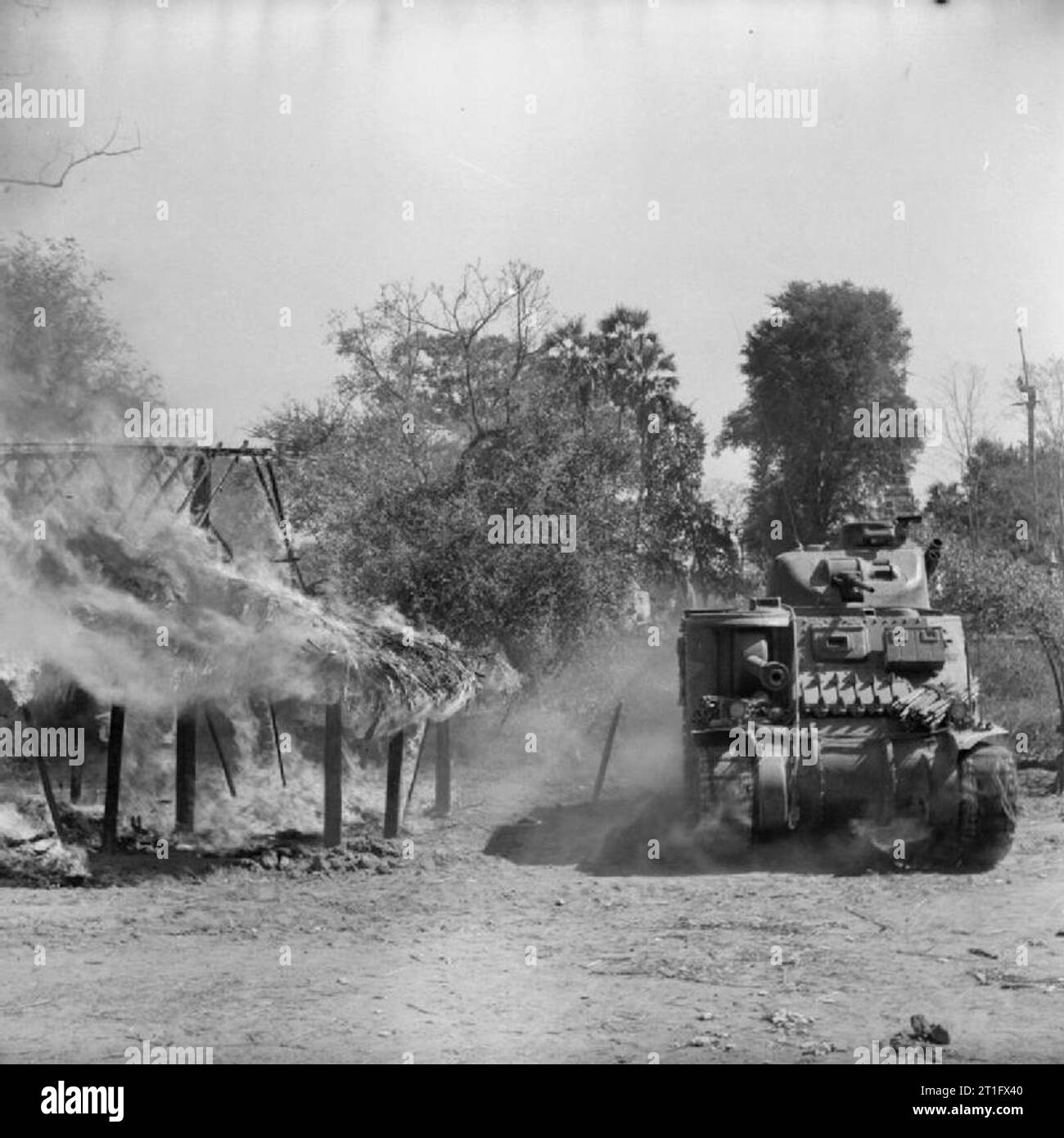 The British Army in Burma 1945 A Lee tank passes a burning building in ...