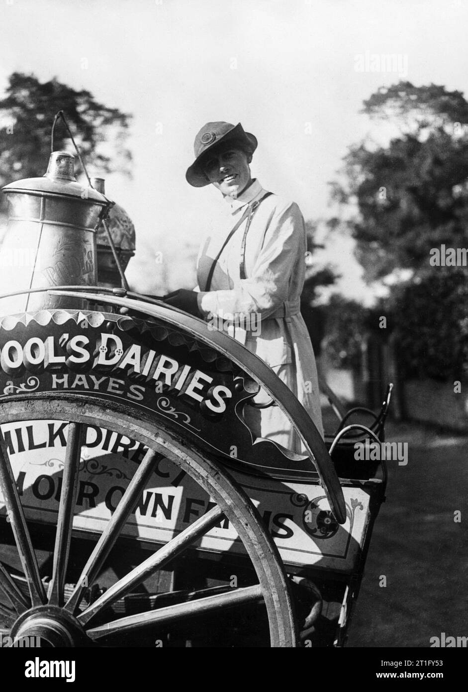 A milkwoman standing on her dairy cart in southern England during the ...