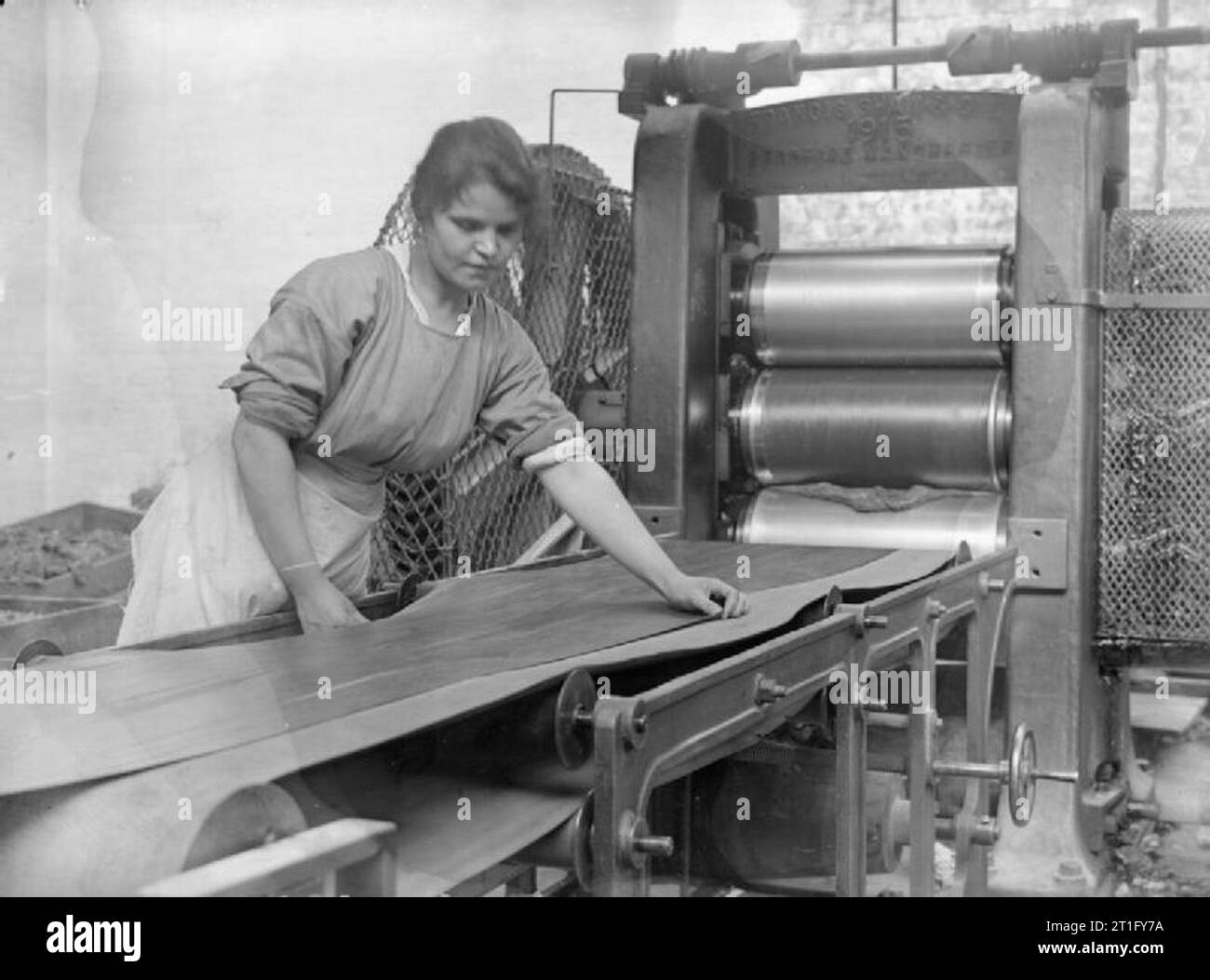 Industry during the First World War A female worker operates a ...
