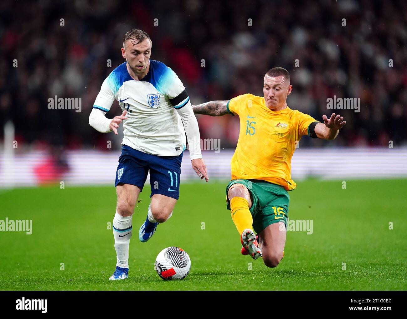 England's Jarrod Bowen (left) challenged by Australia's Mitchell Duke ...
