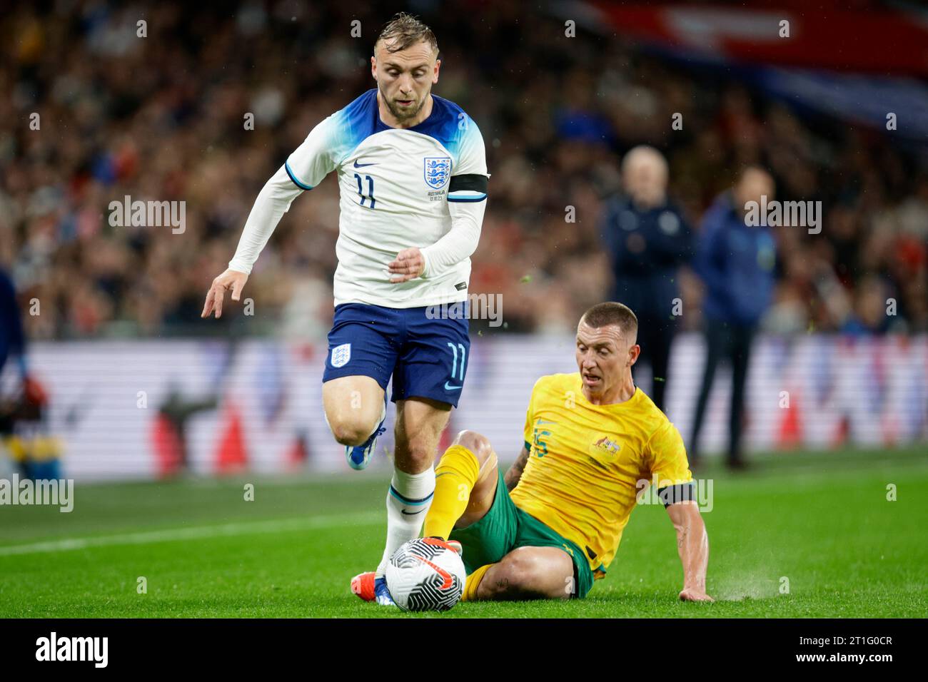 England's Jarrod Bowen, left, duels for the ball with Australia's ...