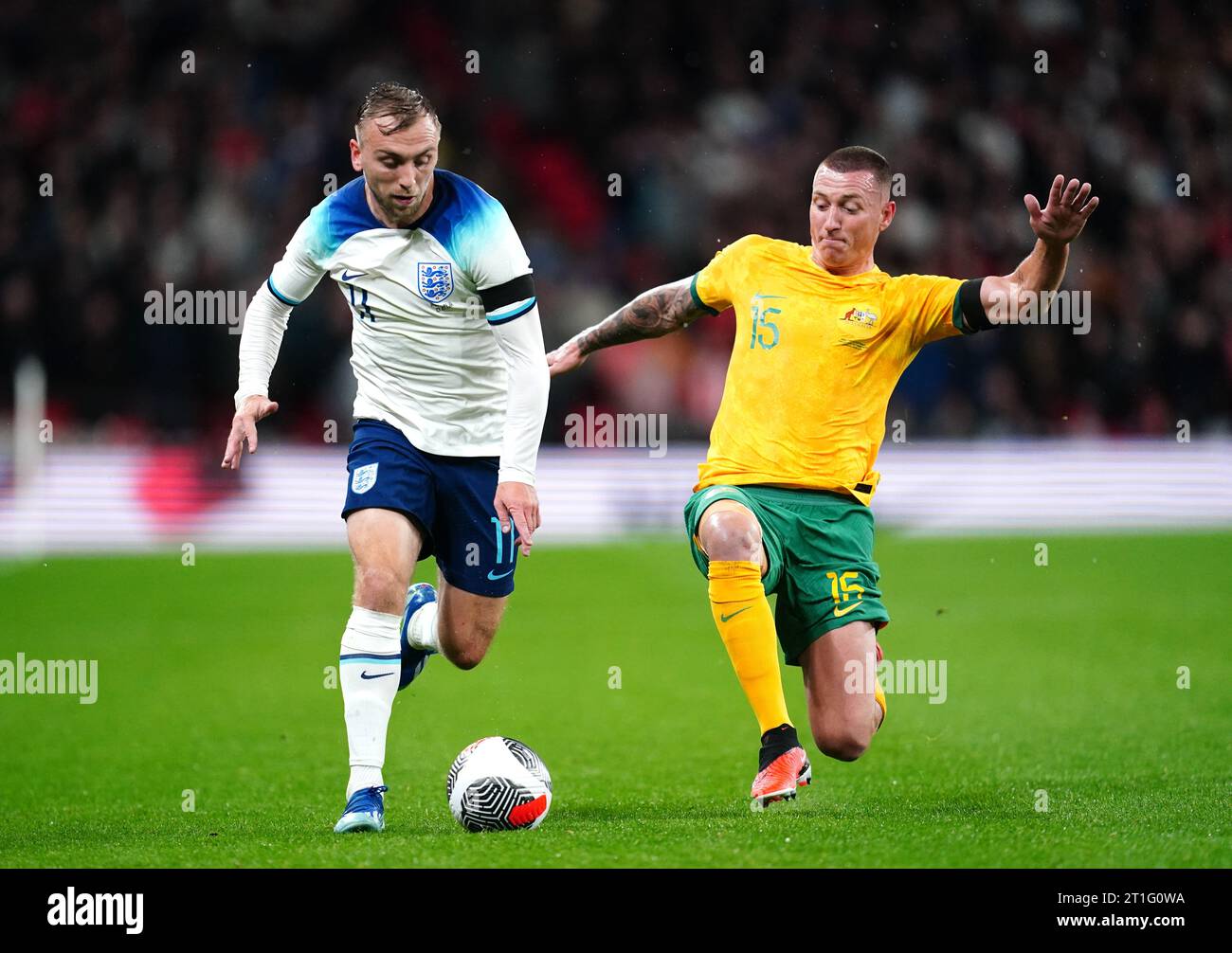 England's Jarrod Bowen (left) challenged by Australia's Mitchell Duke ...