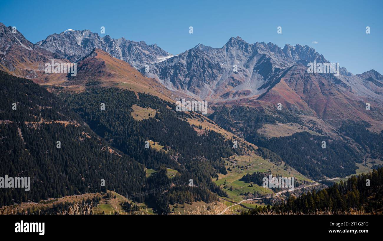 Landscape of the mountains, sky and forest in autumn. Liddes, Valais ...