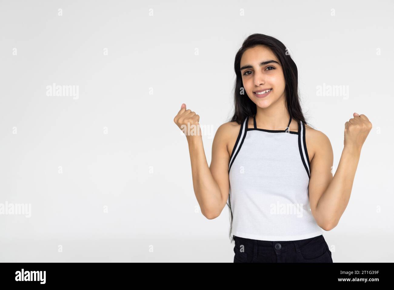 Cheerful young Asian smiling delighted face exults pumping fists ...