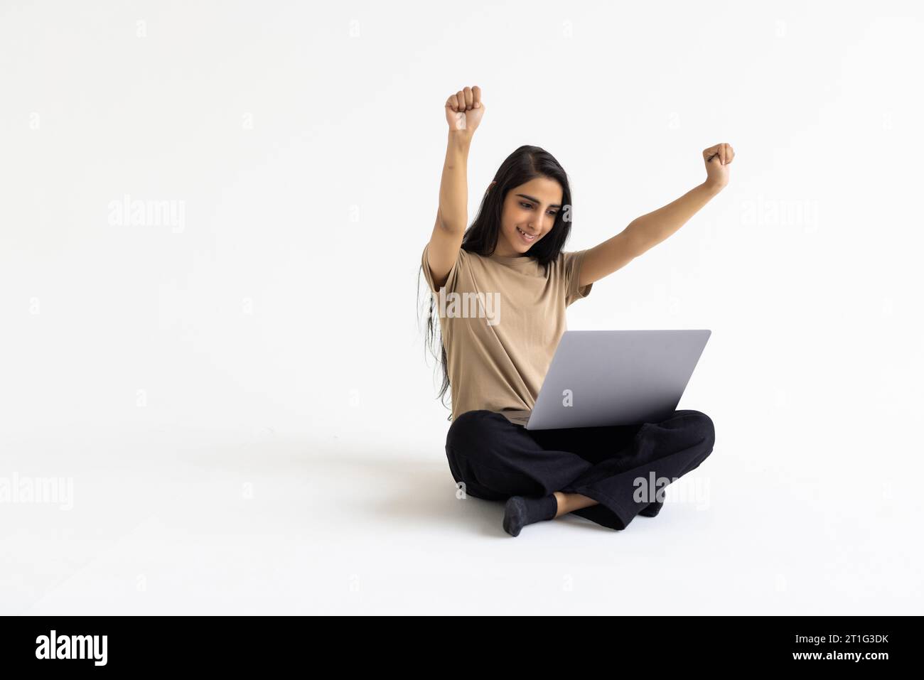 Indian corporate woman using laptop and giving winning expression on ...