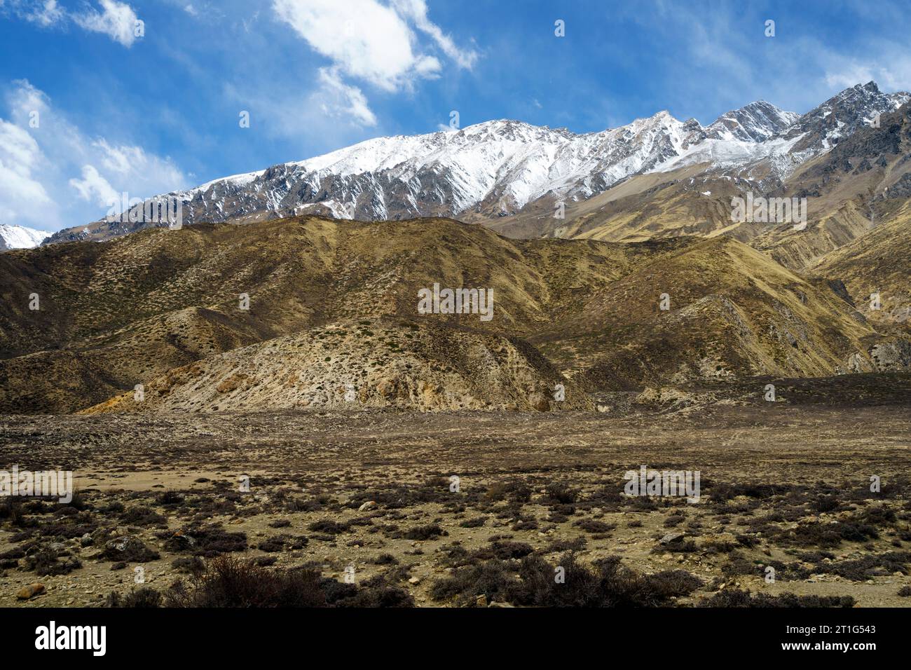 Spectacular desertic landscape with snow capped mountains between ...
