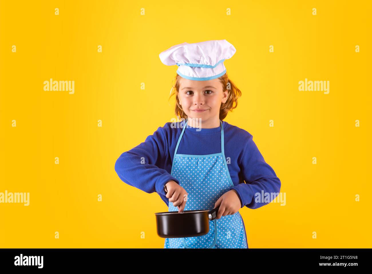 Kid chef cook with cooking pot stockpot. Chef kid boy making healthy ...