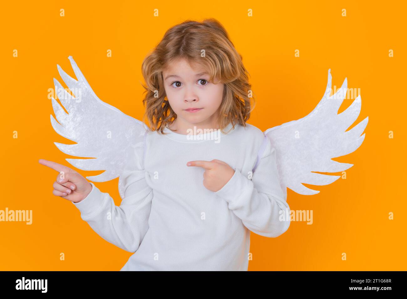 Child angel pointing finger, point gesture. Child at angel costume. Kid ...