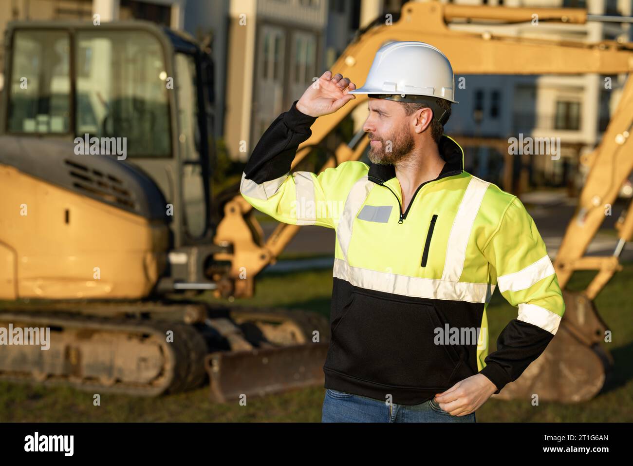 Worker at construction site. Builder in hardhat. Construction man with ...