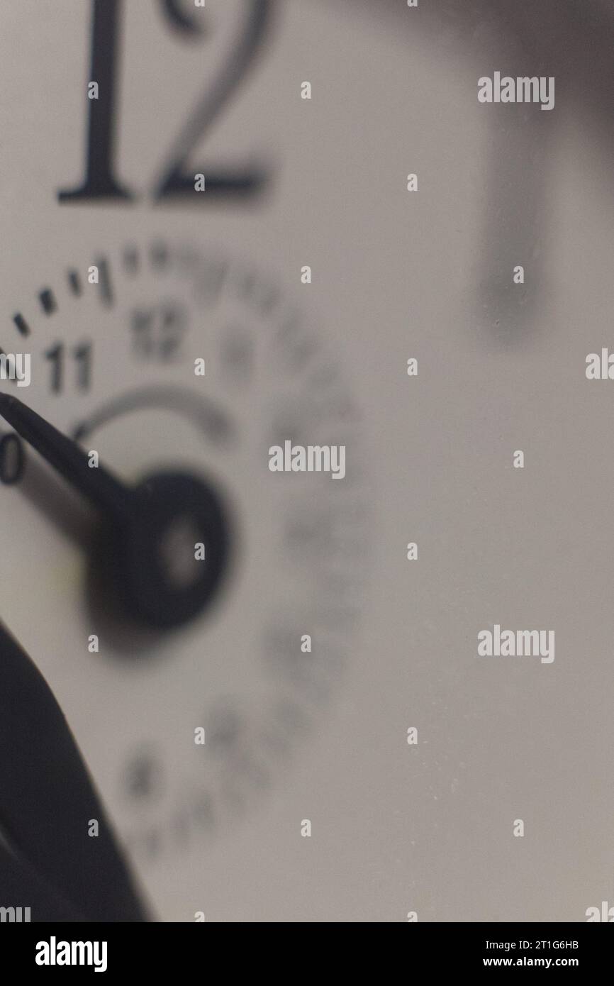 A very close up of an alarm clock's face with dial hand Stock Photo - Alamy