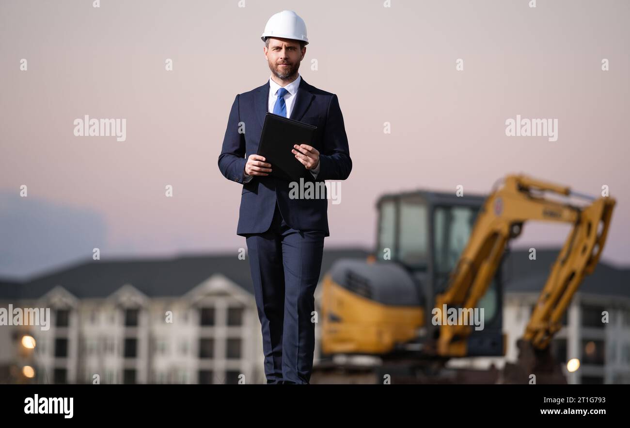Civil engineer worker at a construction site. Engineer man in front of ...