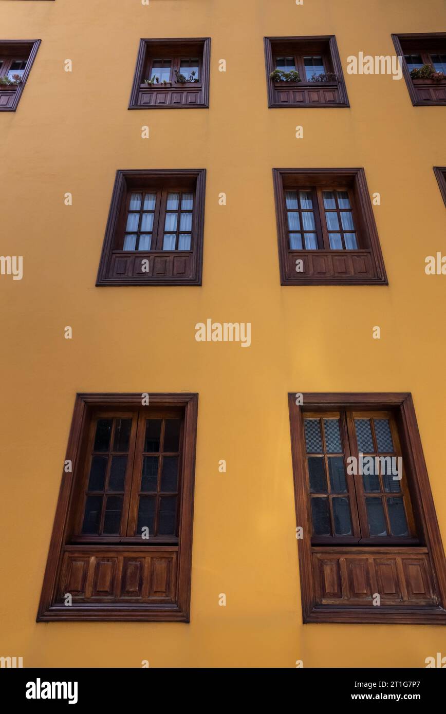 yellow wall and old wooden window frame, building exterior and facade ...