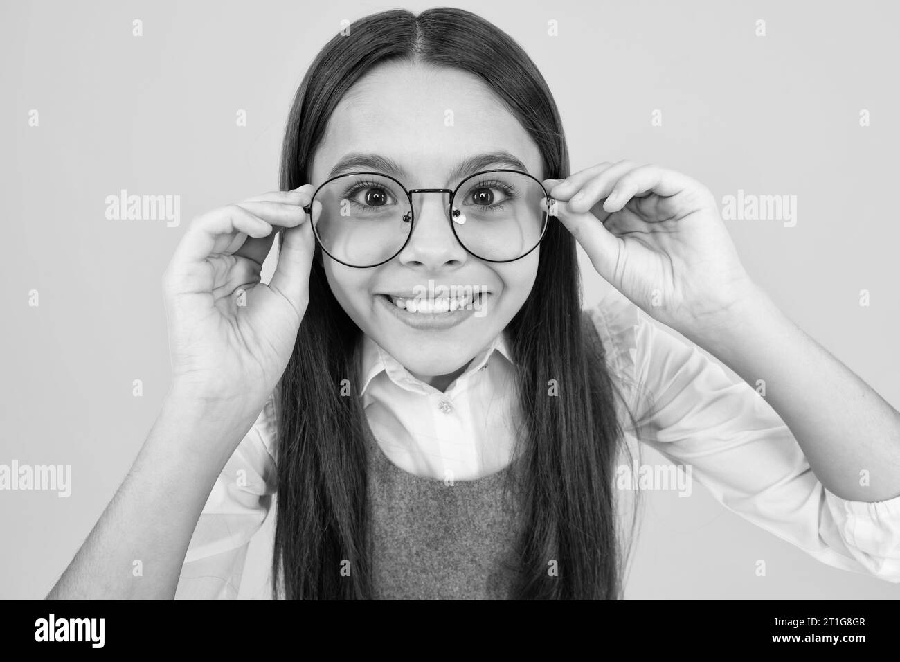 Headshot portrait of cute teenager child girl isolated on yellow studio ...