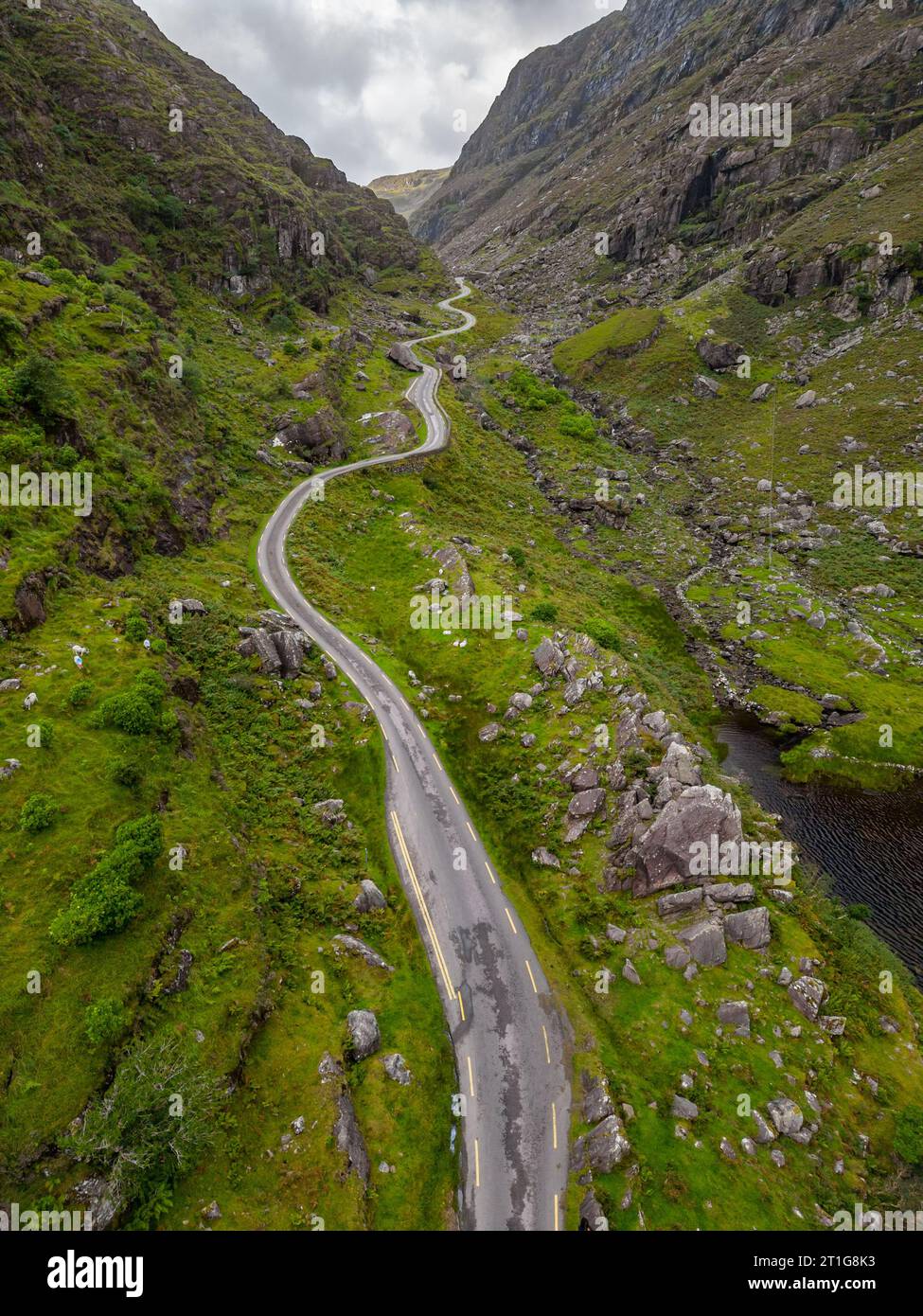 Aerial view of road and lake at Gap of Dunloe with rocks and vegetation ...