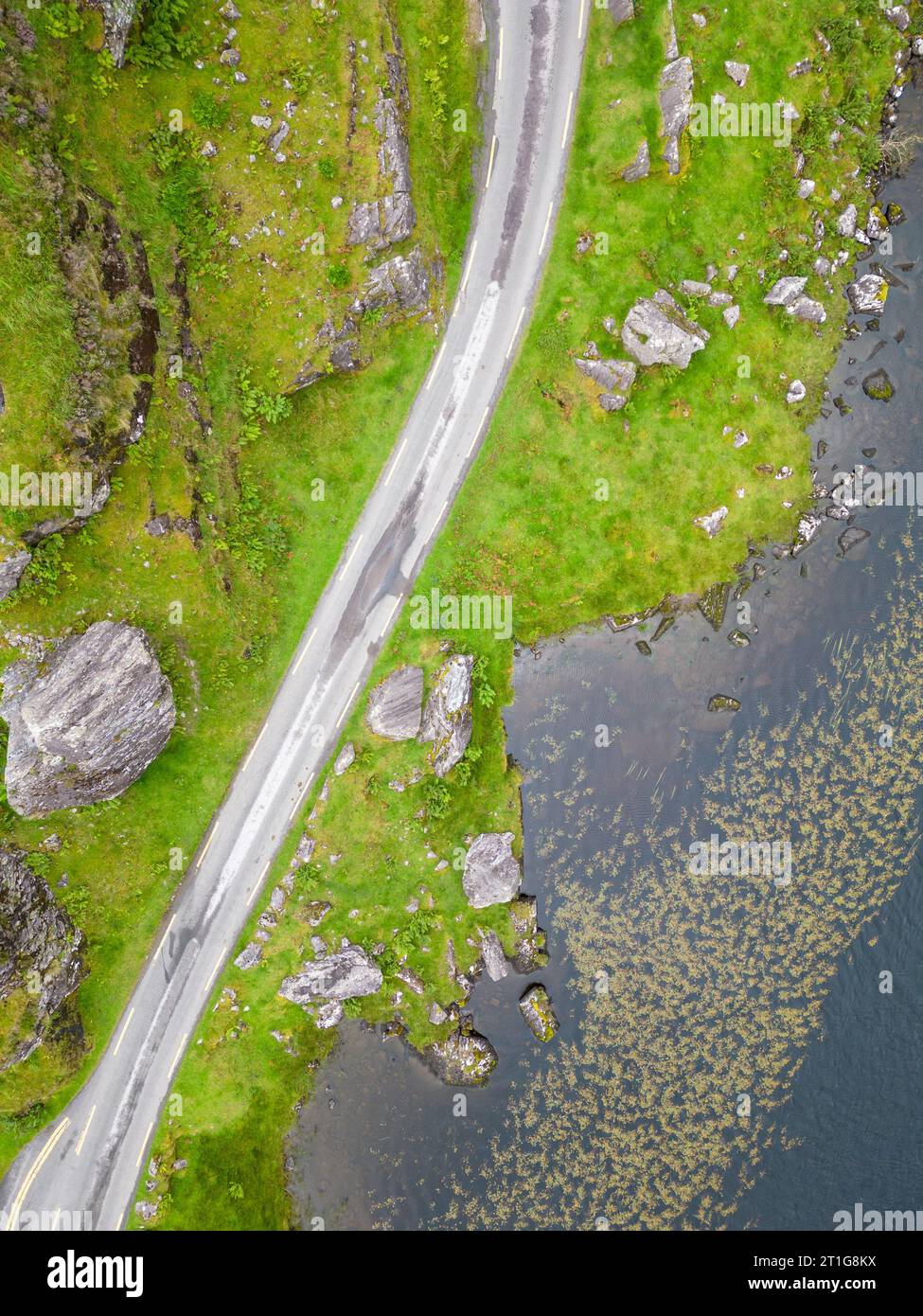 Aerial view of road and lake at Gap of Dunloe with rocks and vegetation ...