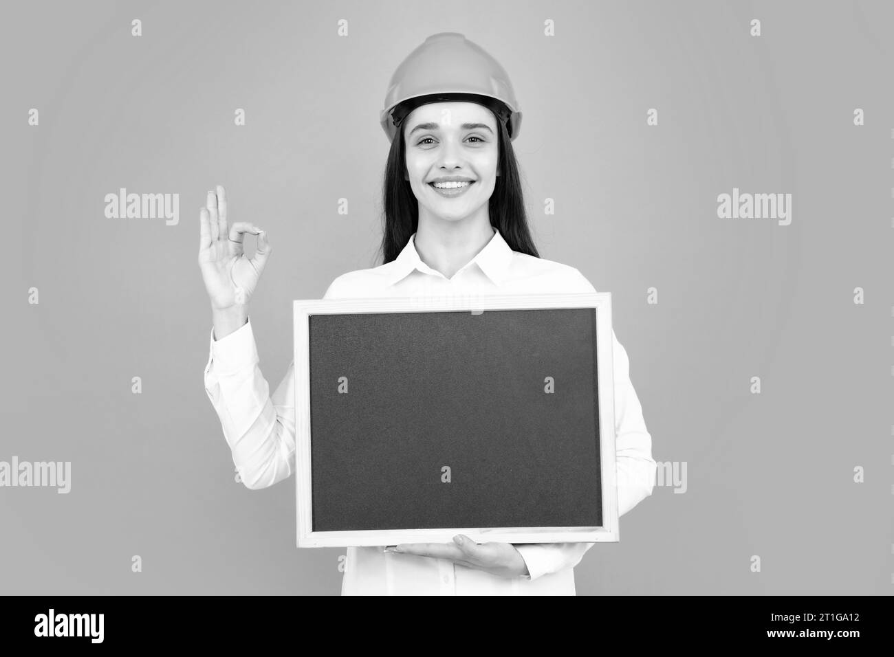 Smiling business builder woman with board, portrait on gray. Woman ...