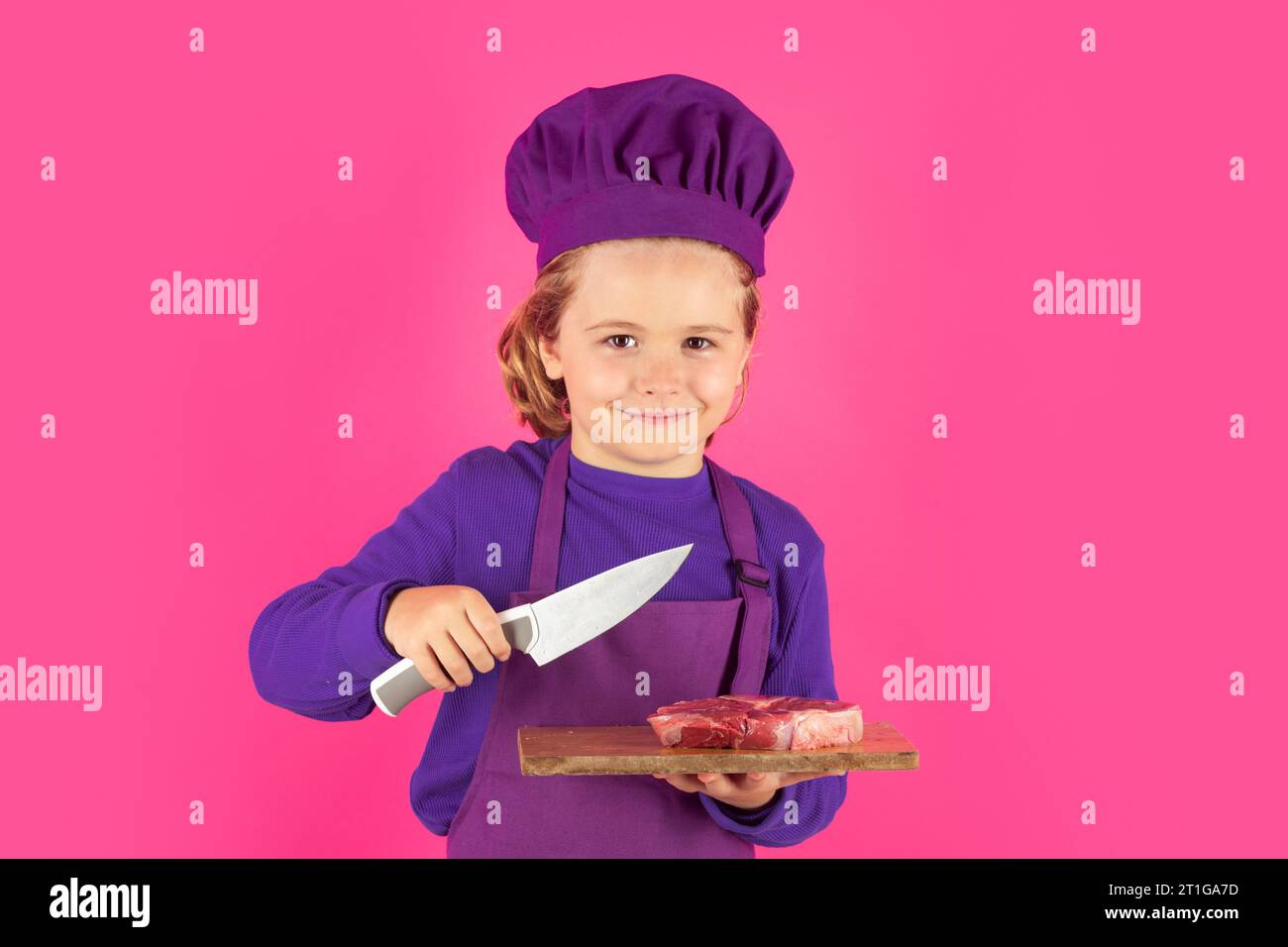 Child cook hold cutting board with meat beef steak and knife. Child in ...