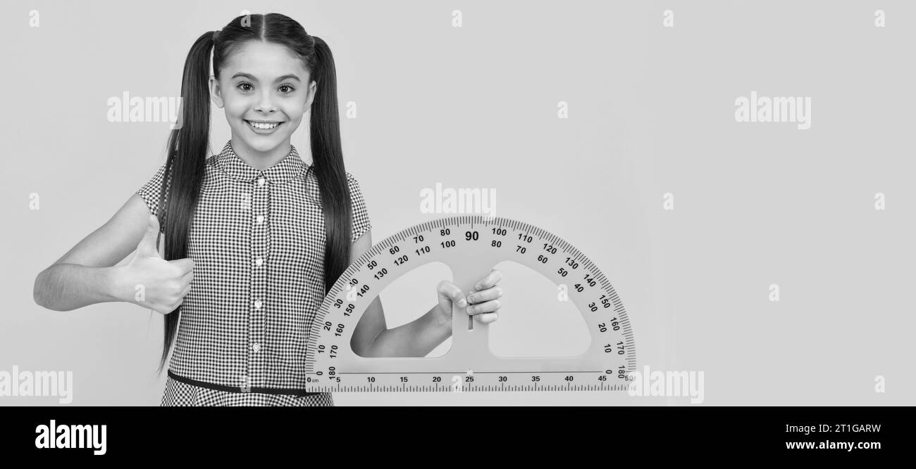 happy child hold school math tool protractor ruler on yellow background ...