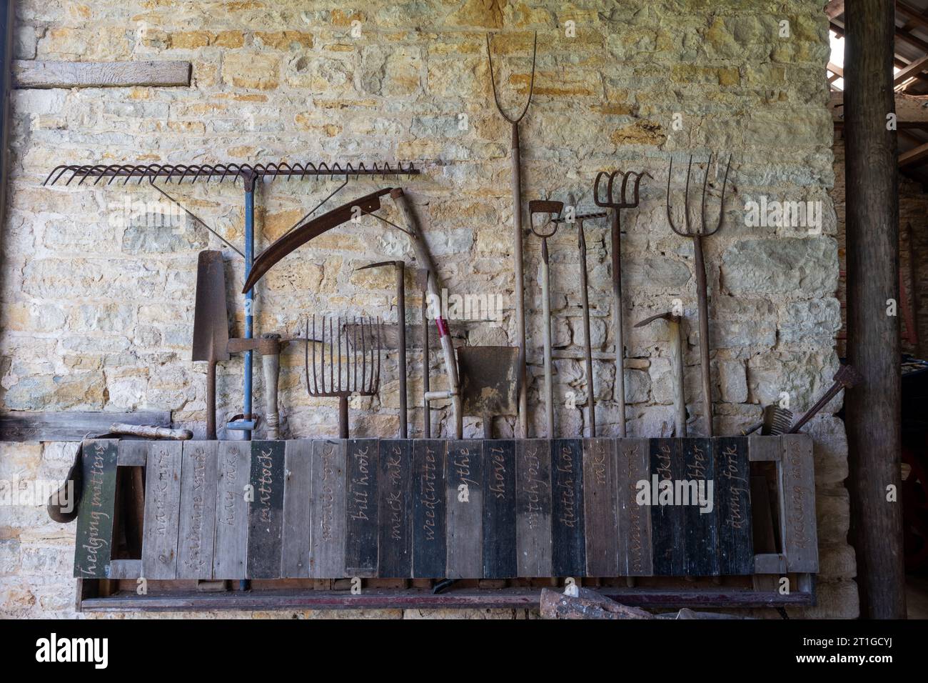 Photo of a selection of antique farm tools inside the barn atTyneham ...