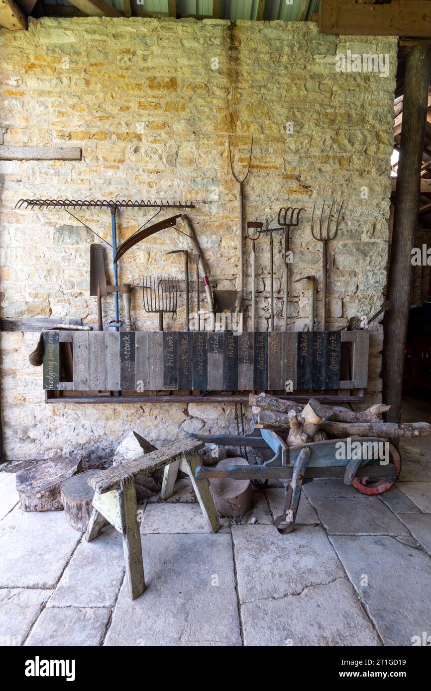 Photo of a selection of antique farm tools inside the barn atTyneham ...