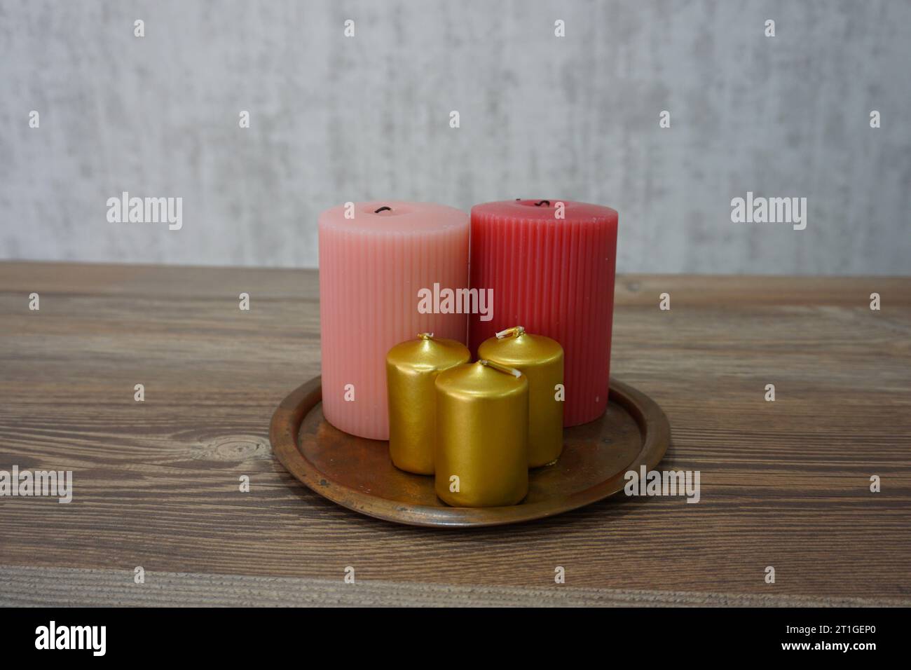Colored candles. pink yellow and red candles. candles of different ...