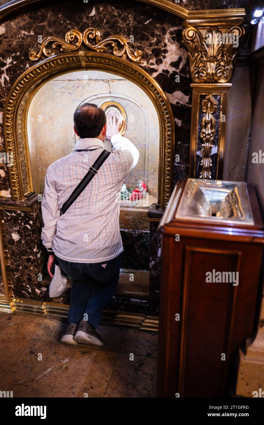 Worshipers kissing the pillar inside the Cathedral-Basilica of Our Lady ...