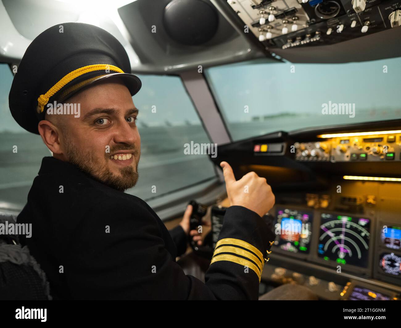 Caucasian bearded man smiling while driving a flight simulator. Pilot ...