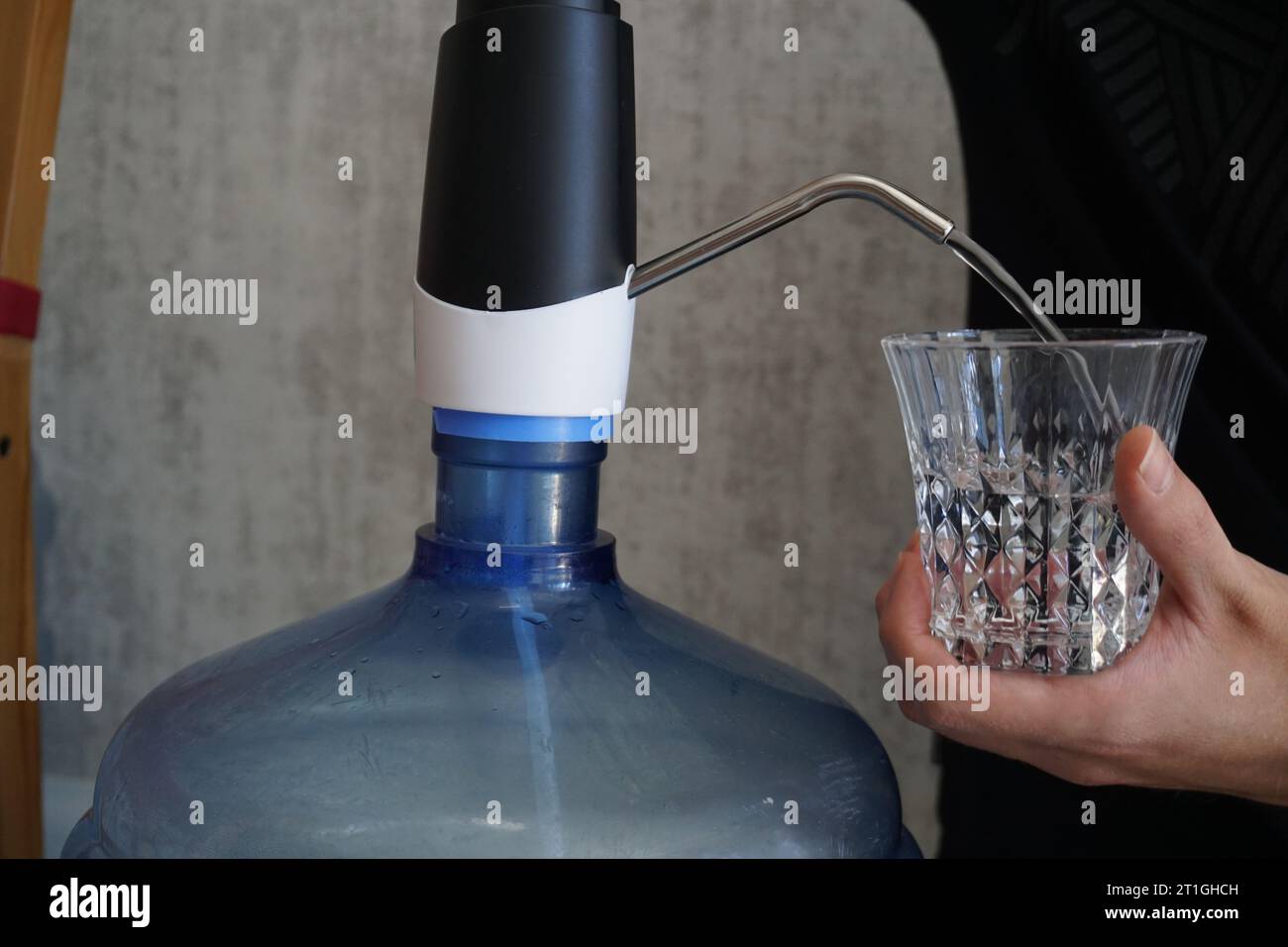 A person filling water. A person who fills water to drink. A person ...