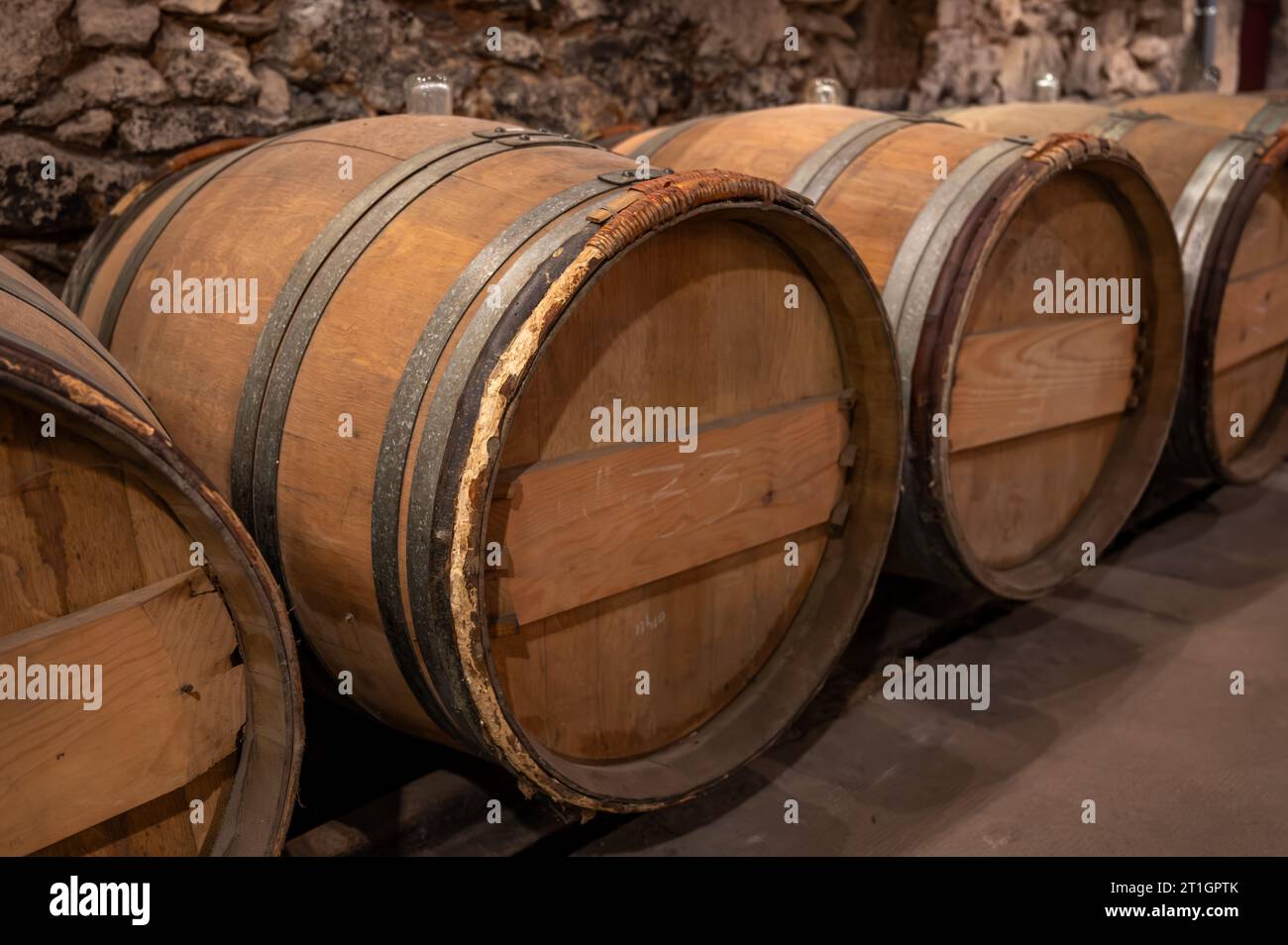 Wine cellar with oak wooden barrels in old wine domain on Sauternes ...