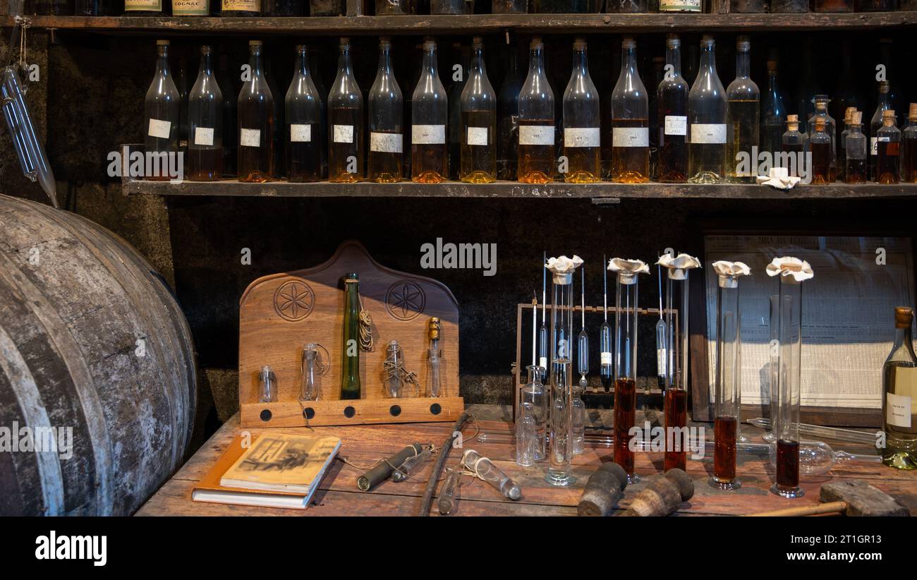 Blending process of cognac spirit and old dark French oak barrels in ...