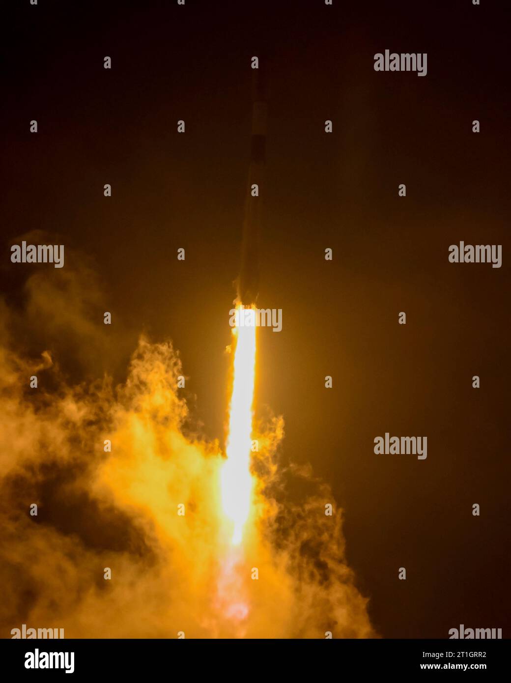 A SpaceX Falcon 9 rocket passes through a low cloud deck as it launches ...