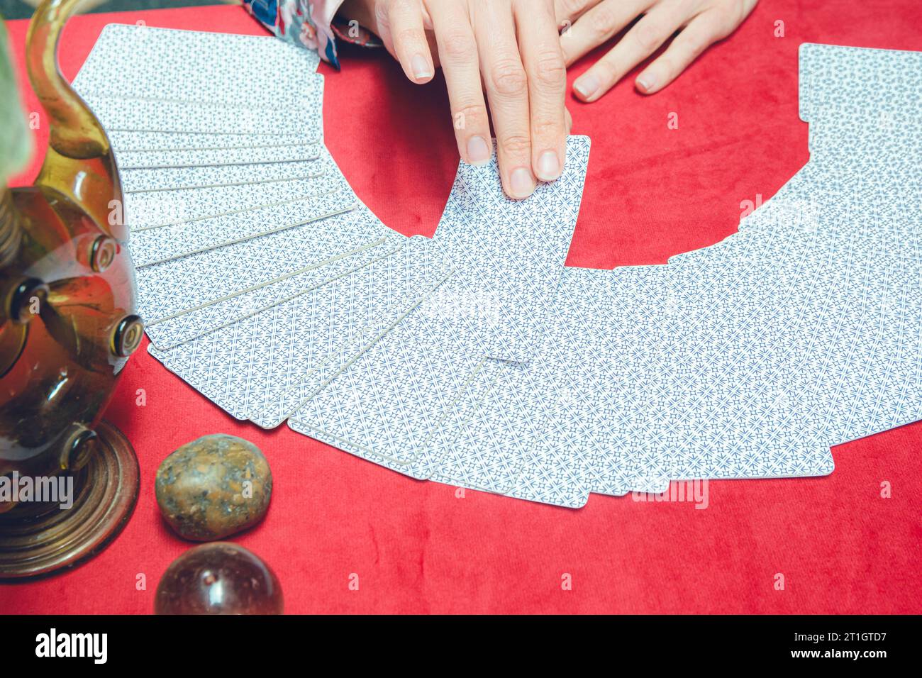 top view of unrecognizable caucasian adult woman taking tarot deck from ...
