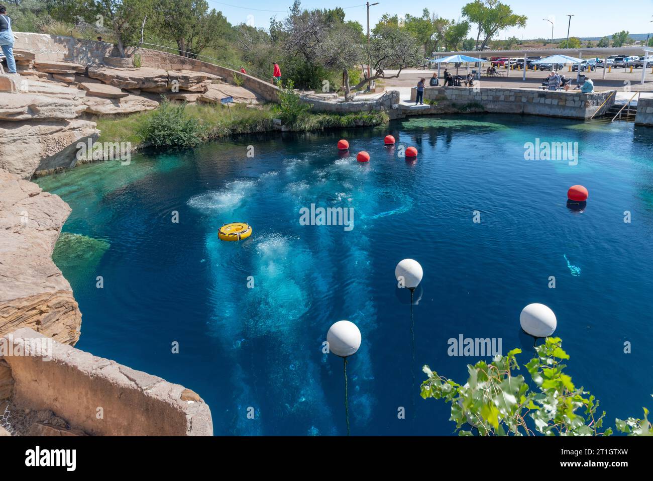 Bubbles from scuba divers in the clear blue water of the Blue Hole of ...