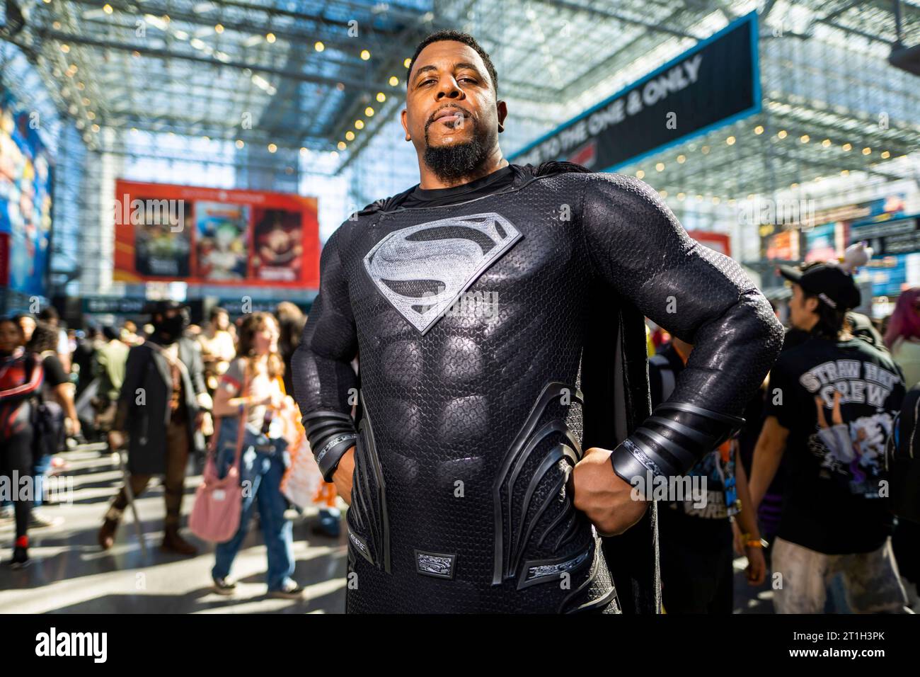 An attendee dressed as Superman poses during New York Comic Con at the ...