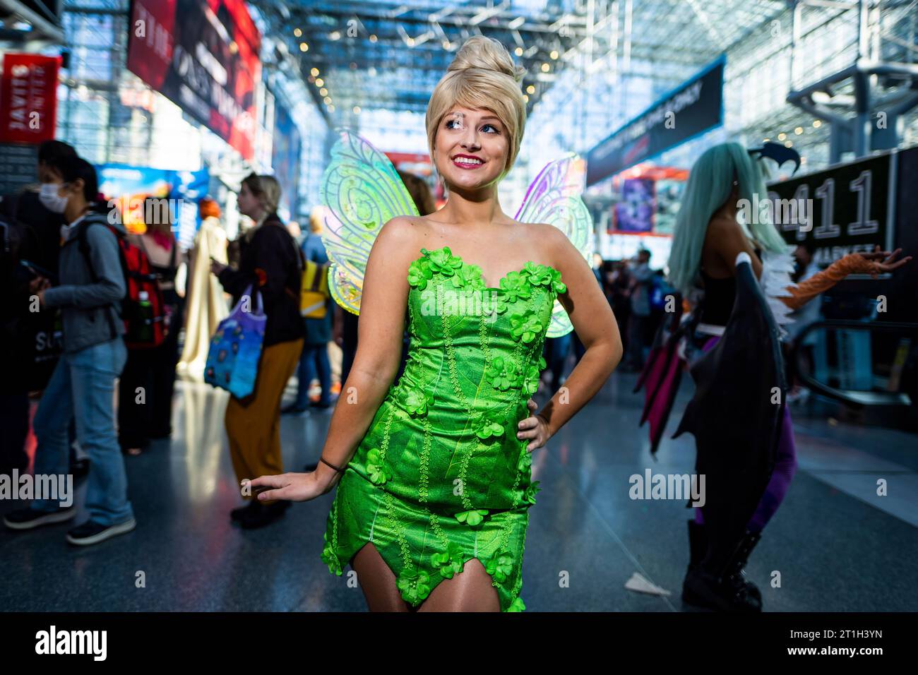 An attendee dressed as Tinker Bell poses during New York Comic Con at ...