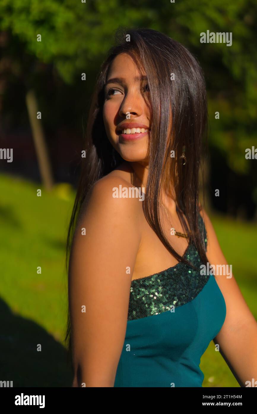 A pretty young brunette Latina with long straight hair, wearing a tight ...