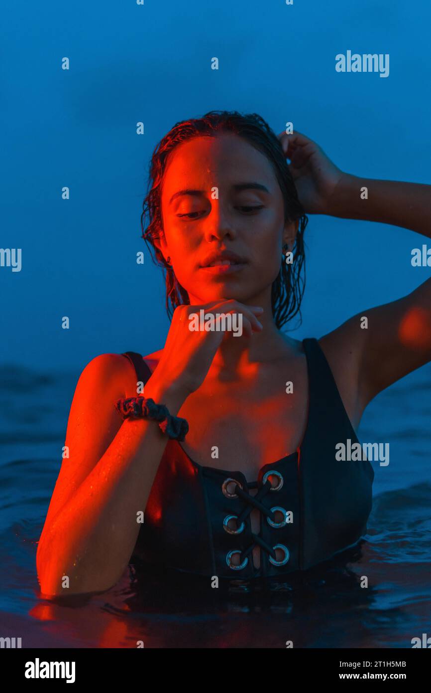 Lifestyle of a young pretty brunette Caucasian bathing at night in the ...