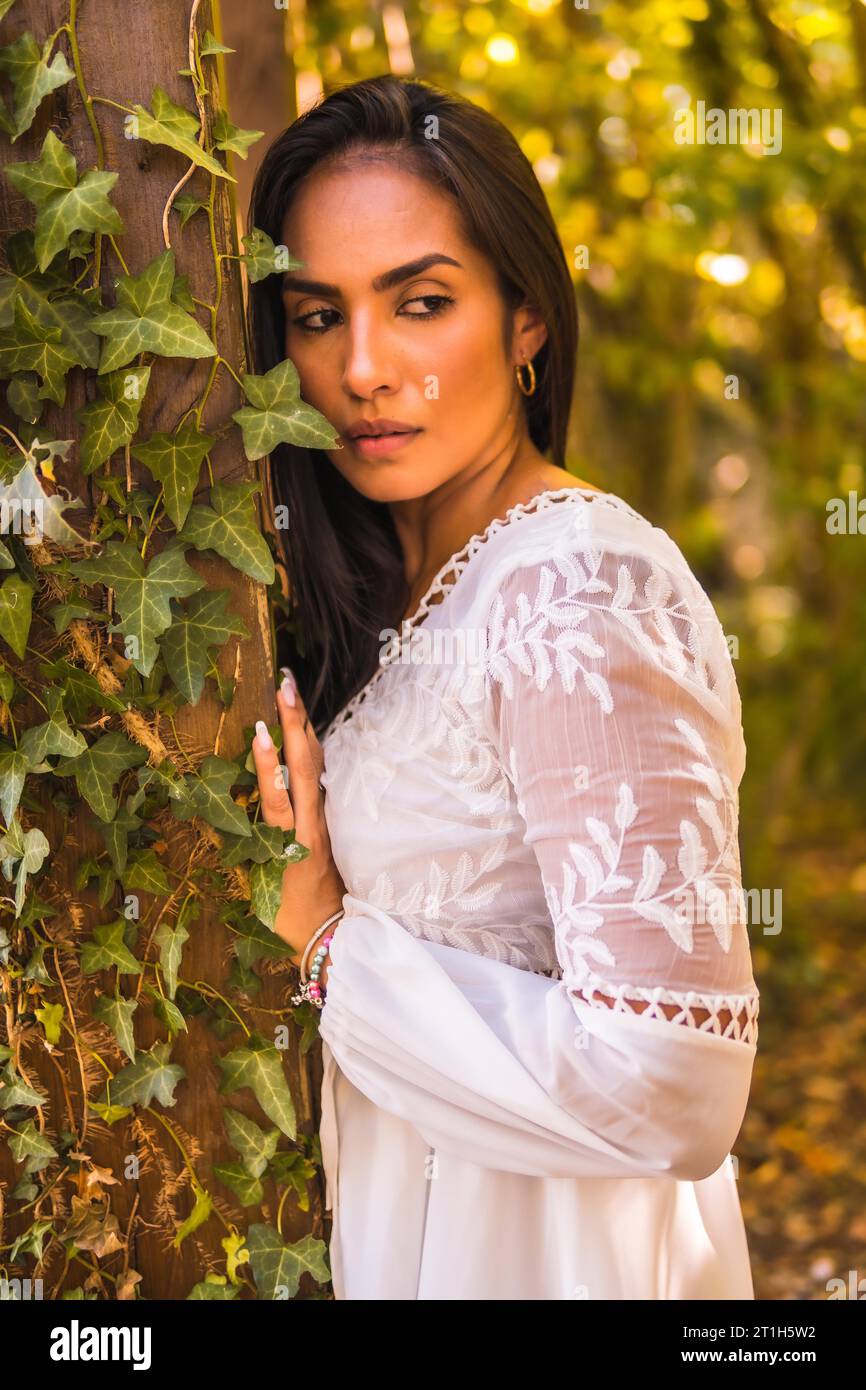 Lifestyle, brunette girl with straight hair in a beautiful white dress ...