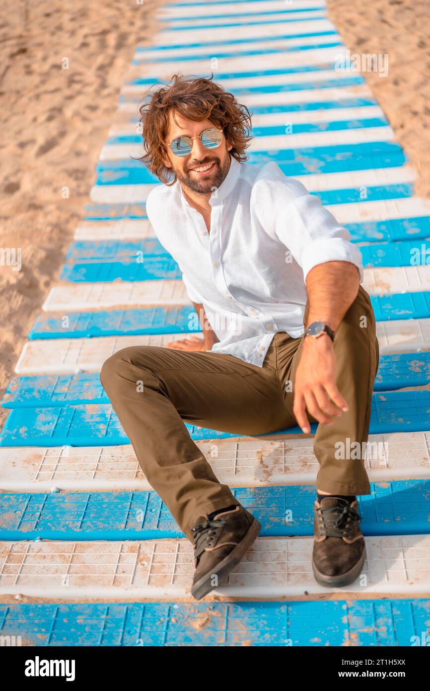 Summer lifestyle with a young dark-haired Caucasian man with long beard ...