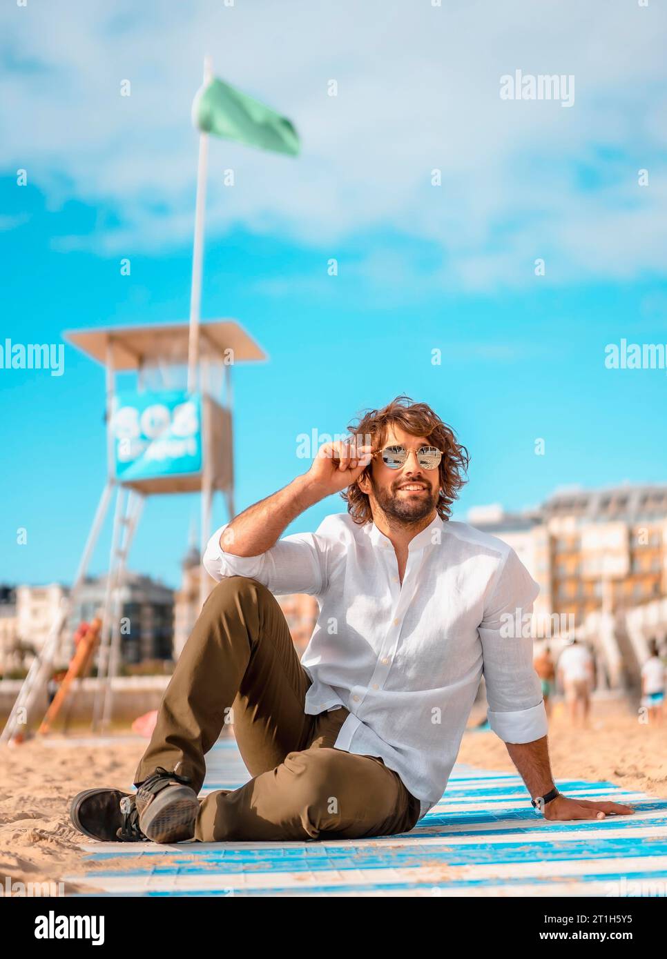 Summer lifestyle with a young dark-haired Caucasian man with long beard ...