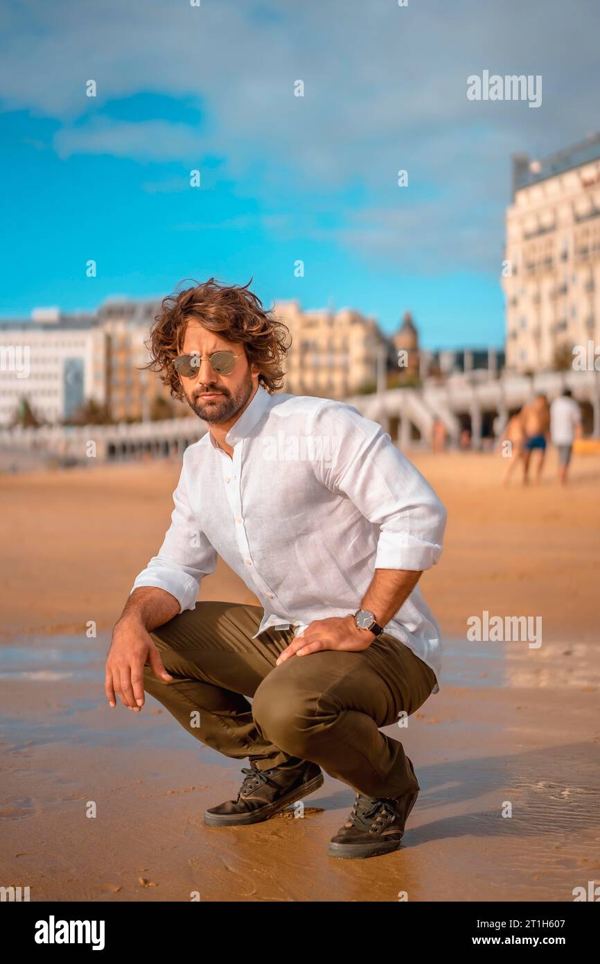 Summer lifestyle with a young dark-haired Caucasian man with long beard ...