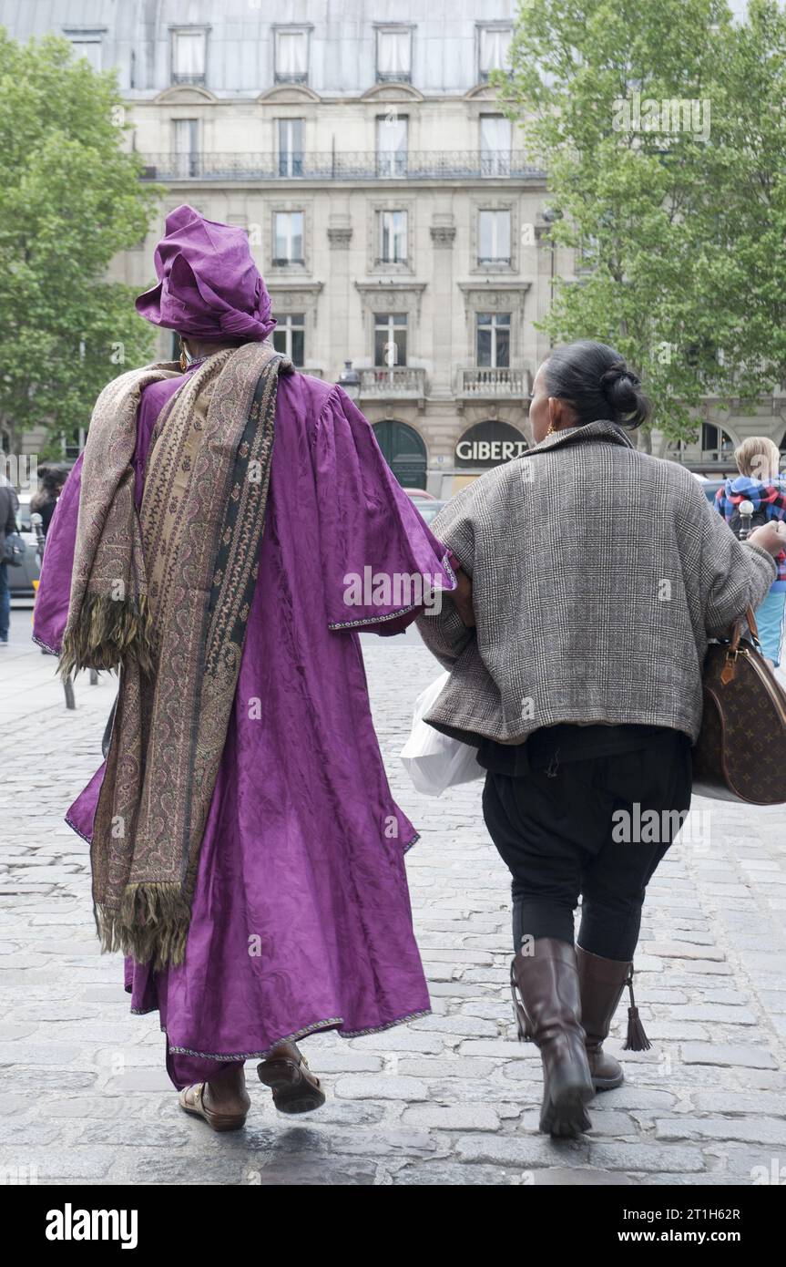 Two women of contrasting body size, stroll together on the Left Bank ...
