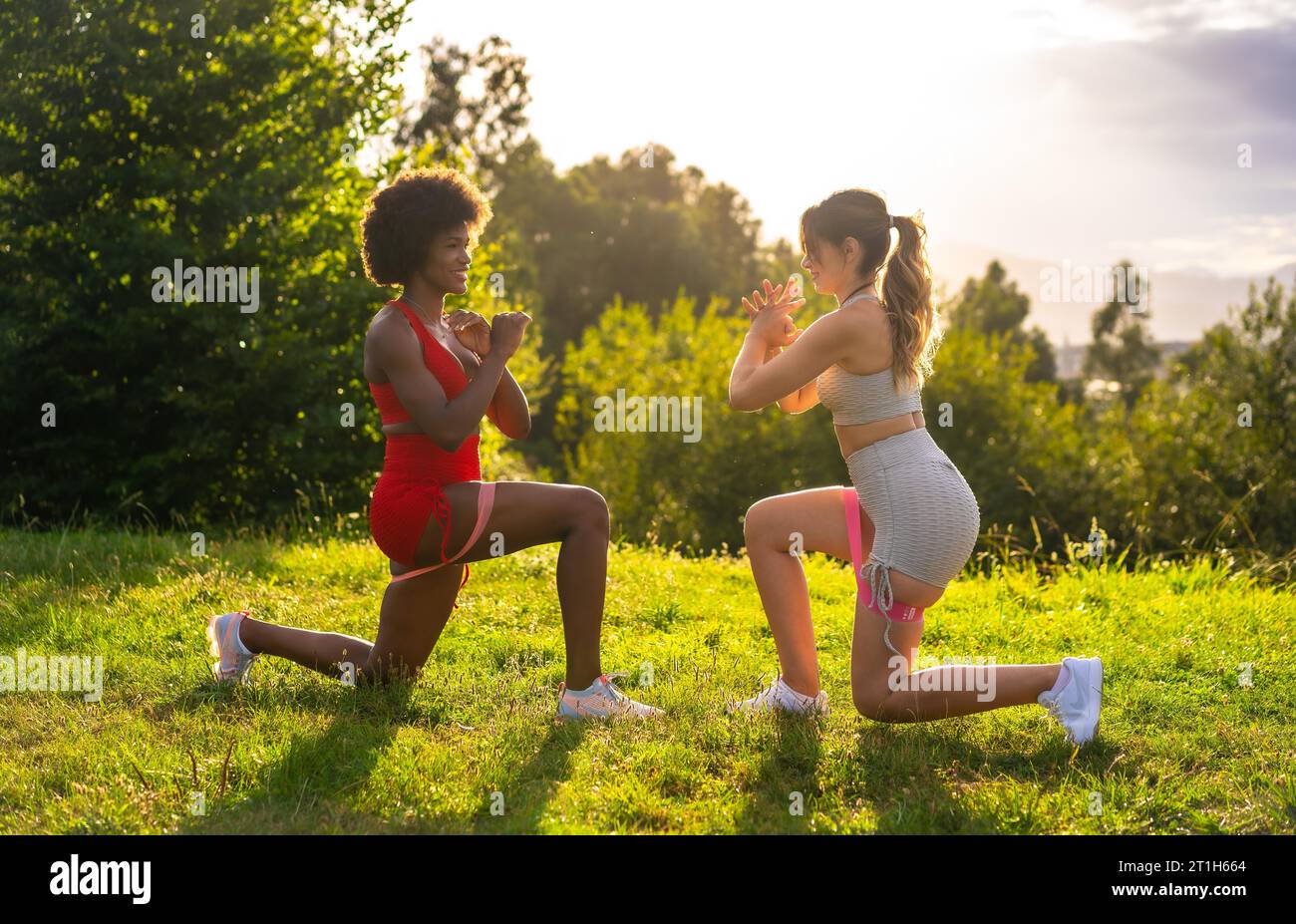 Caucasian blond girl and dark-skinned girl with afro hair doing ...